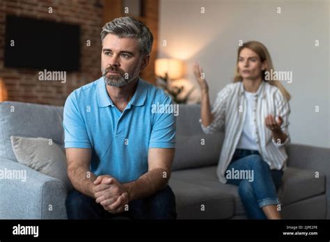 Offended Unhappy Mature Caucasian Woman Scolds At Sad Husband Man