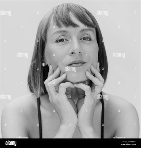 Black And White Portrait Of A Young Woman Cradling Her Chin In Her