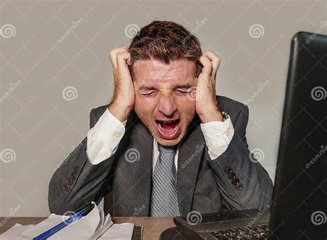 Stressed And Overwhelmed Businessman In Suit And Tie Working At Office