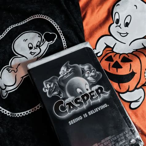 The Casper Book Is Laying Next To An Orange And Black T Shirt With