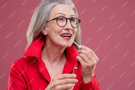 Premium Photo Makeup Good Looking Mid Aged Woman Putting Lip Gloss