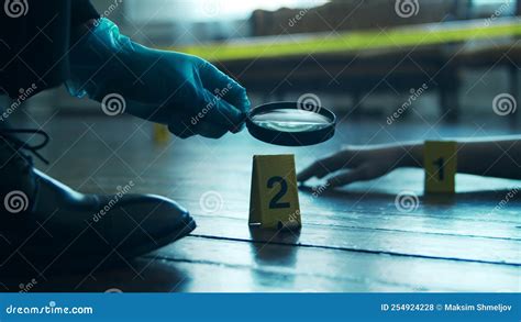 Detective Collecting Evidence In A Crime Scene Forensic Specialists
