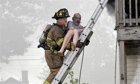 The Moment Firefighters Carry An Elderly Man Down A Ladder To Safety