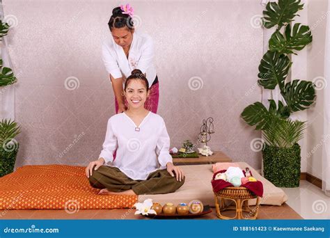 Smile Young Woman Getting Thai Herbal Massage With Hand Of Masseuse On