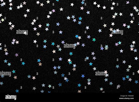 Iridescent Silver Stars Confetti On Black Festive Holiday Background