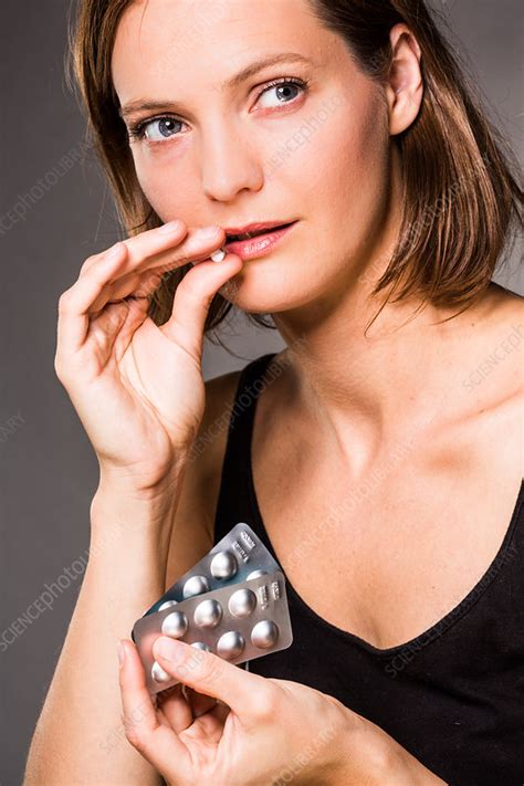 Woman Taking Statin Cholesterol Lowering Pills Stock Image C034