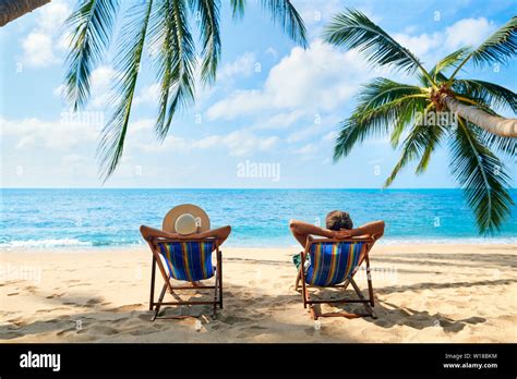 Couple Relax On The Beach Enjoy Beautiful Sea On The Tropical Island