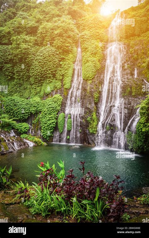 Jungle Waterfall Cascade In Tropical Rainforest With Rock And Turquoise