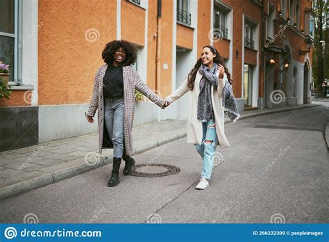 Love Holding Hands And Lesbian Couple Walking In Street Enjoying