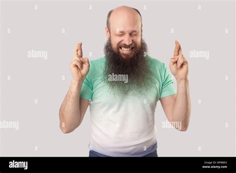 Portrait Of Hopeful Middle Aged Bald Bearded Man In Green T Shirt