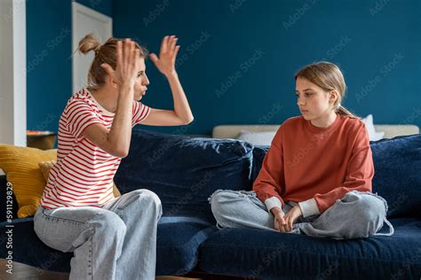 Young Angry Emotional Mother Screaming At Troubled Teen Daughter