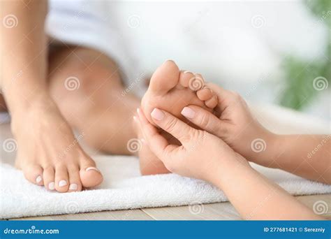 Beautiful Young Woman Receiving Foot Massage In Spa Salon Stock Image