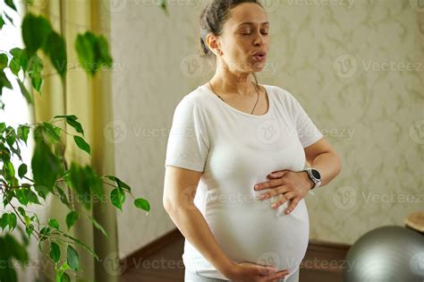 Pregnant Woman Putting Her Hands On Her Big Belly Training Breathing