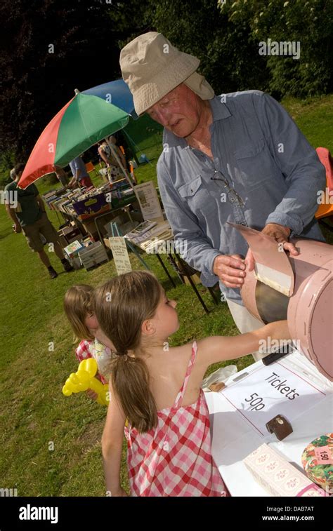 6 Year Old Girl Trying Her Luck At The Tombola At A Summer Fete East