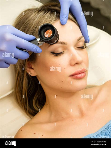 Doctor Dermatologist Examines Moles And Birthmarks Of Female Patient