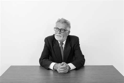Premium Photo Portrait Of Man Sitting On Table
