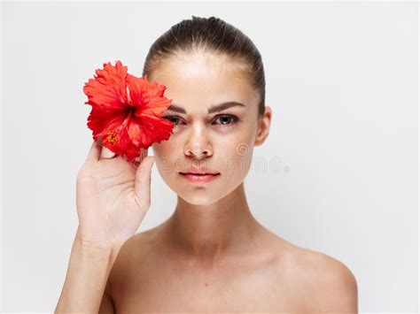Pretty Woman With Red Flower Near Face Naked Shoulders Stock Image