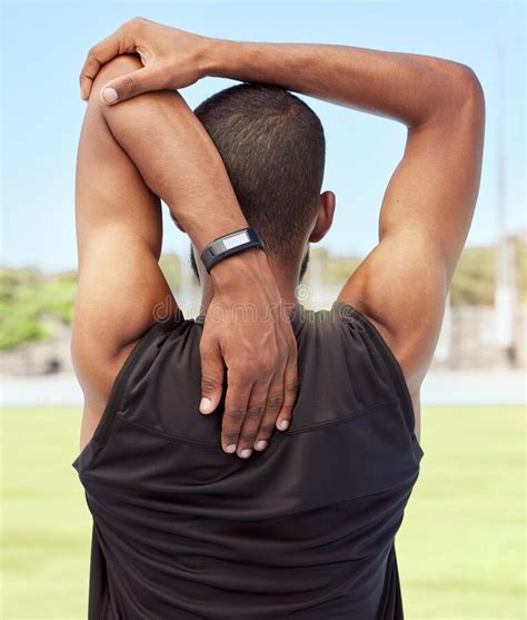 Athletic Man Preparing For Fitness And Exercise By Stretching And