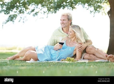 What A Perfect Day For A Picnic A Smiling Husband And Wife Enjoying A