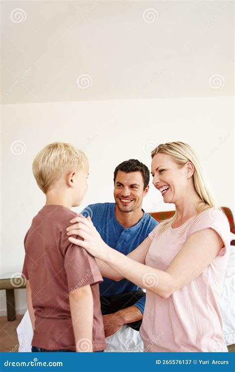 We Are So Proud Of You Son A Happy Mother And Father Doting Over Their