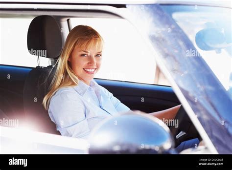 Smiling Female Sitting In The Drivers Seat Of A Car Portrait Of A