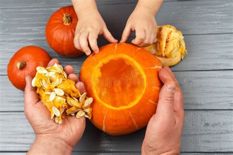 Hands Of A Daughter And Father Who Pulls Seeds And Fibrous Material