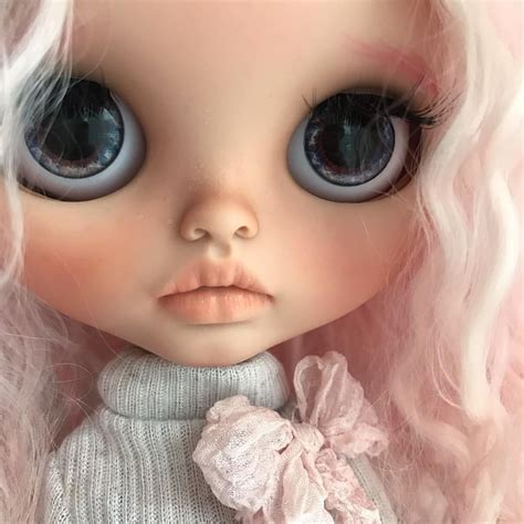 A Close Up Of A Doll With Big Blue Eyes