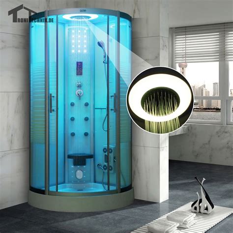 A Bathroom With A Round Shower In The Middle And A Circular Light Above