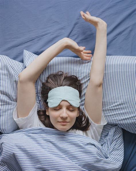 Top View Of A Woman In Bed Wearing A Sleep Mask A Happy European Woman