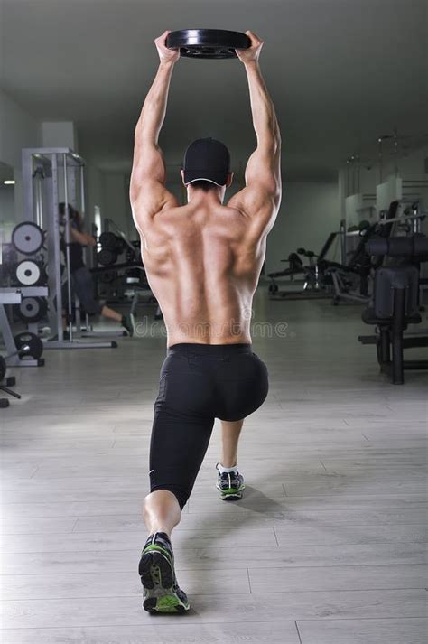 Handsome Powerful Athletic Man Doing Complex Exercise With Weight Stock