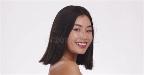 Playful Nude Asian Girl Turning Around And Smiling At Camera Stock