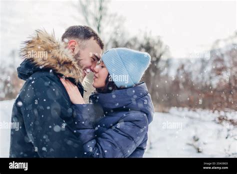 Man And Woman Kissing And Hugging In Winter Forest Couple Enjoying