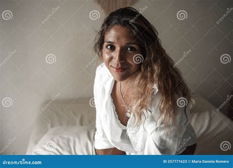 Portrait Of A Beautiful Latina Woman Lying On Her Bed In The Morning