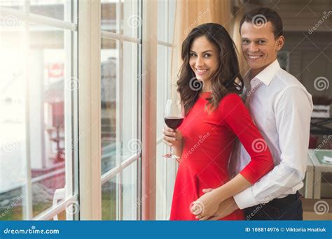 Young Couple Having Romantic Dinner In The Restaurant Standing Near The