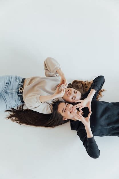 Premium Photo Cheerful Lesbians Embrace Passioantely And Have Fun