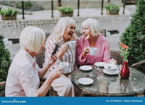 Two Women Having Shopping Carts And Choosing Goods In Cosmetics Stock