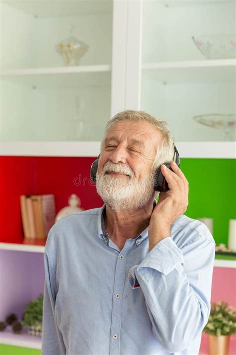 Senior Retirement Man Listen To Music Using Headphone Feeling Happy In