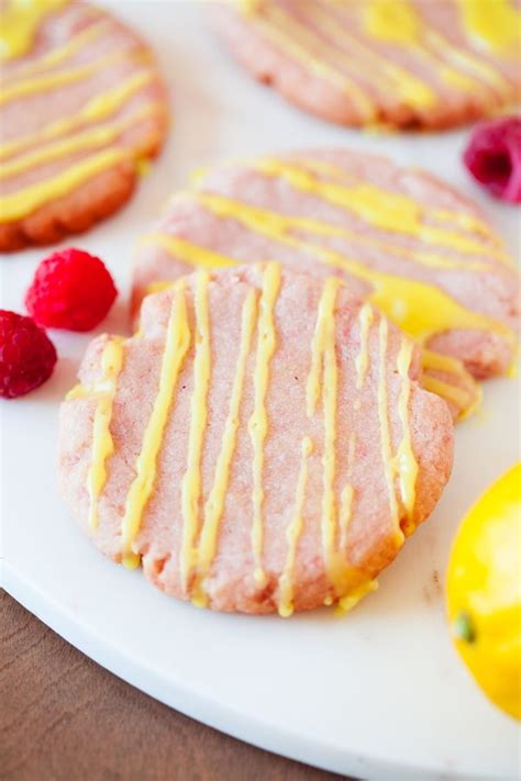 Raspberry Lemon Cookies With Icing On A White Plate