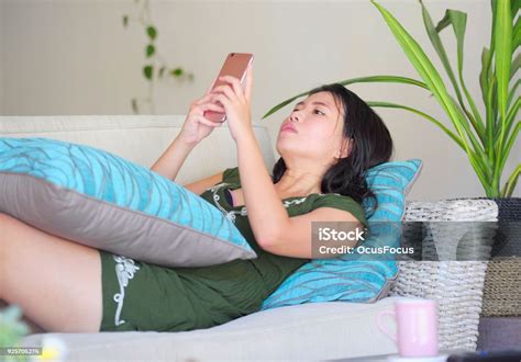 Young Beautiful And Relaxed Asian Chinese Woman Lying At Home Living