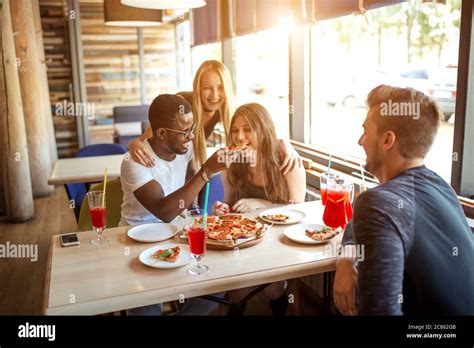 Young Multiracial Diverse Colleagues Eating Pizza During Their Lunch