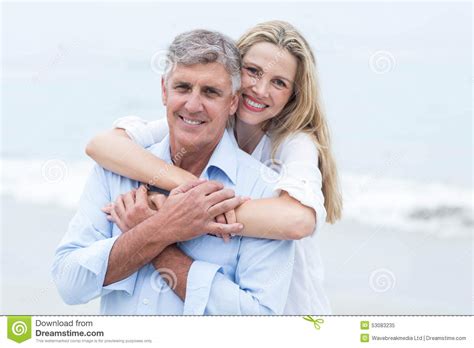 Happy Couple Hugging Each Other And Looking At Camera Stock Image