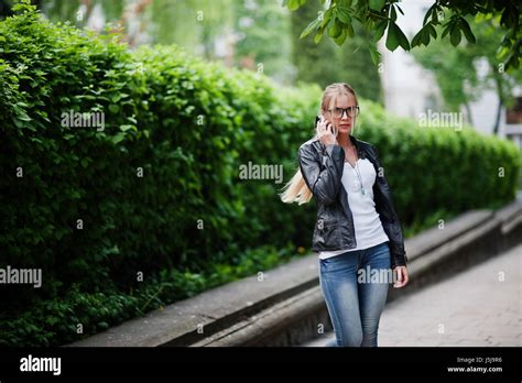 Stylish Blonde Woman Wear At Jeans Glasses And Leather Jacket With