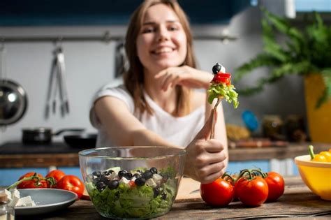 Premium Photo Girl Eating Vegetarian Salad At Home In The Kitchen She