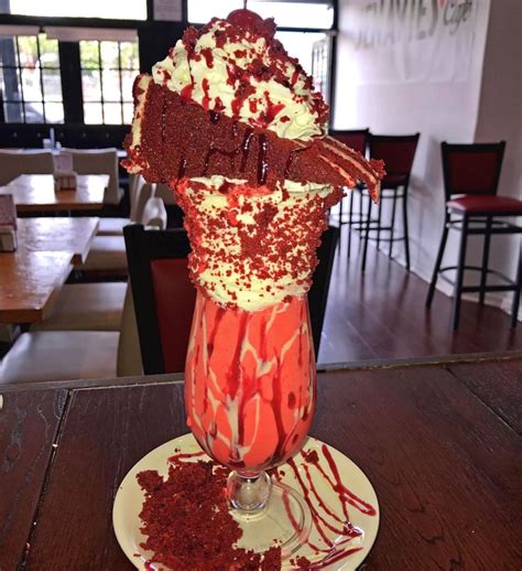 Red Velvet Milkshake With A Huge Slice Of Red Velvet Cake On Top