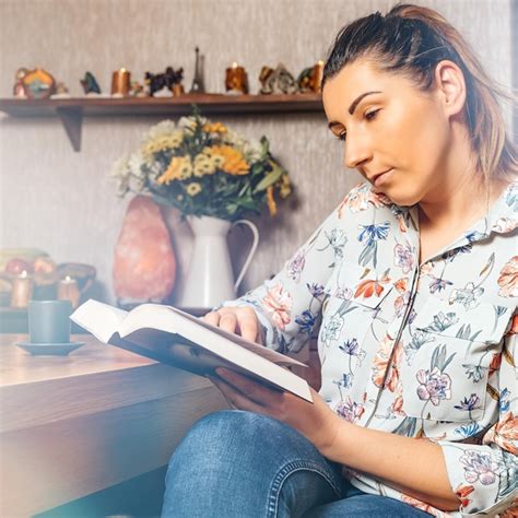 Premium Photo Woman Reading Book While Sitting At Home