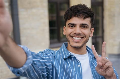 Premium Photo Smiling Indian Man Holding Mobile Phone Taking Selfie