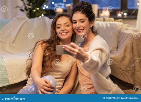Female Friends Taking Selfie By Smartphone At Home Stock Image Image