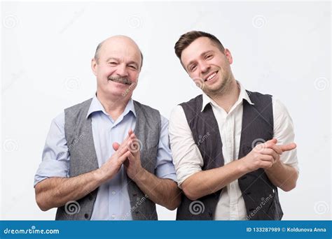 Happy Handsome Men Applauding Clapping Hands And Looking Away Stock