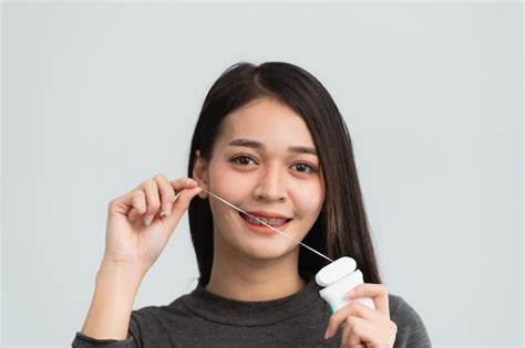 Premium Photo Asian Woman Braces Using Dental Floss Teeth Braces On