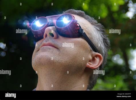 Man Watching A Sun Eclipse Through Safety Glasses Looking At The Solar